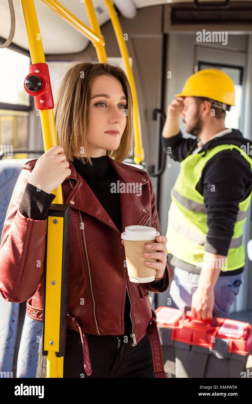 woman with coffee to go in bus Stock Photo - Alamy