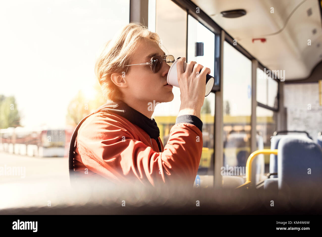 man drinking coffee in bus Stock Photo - Alamy