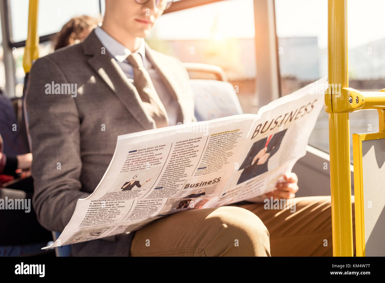 man with newspaper in bus Stock Photo - Alamy