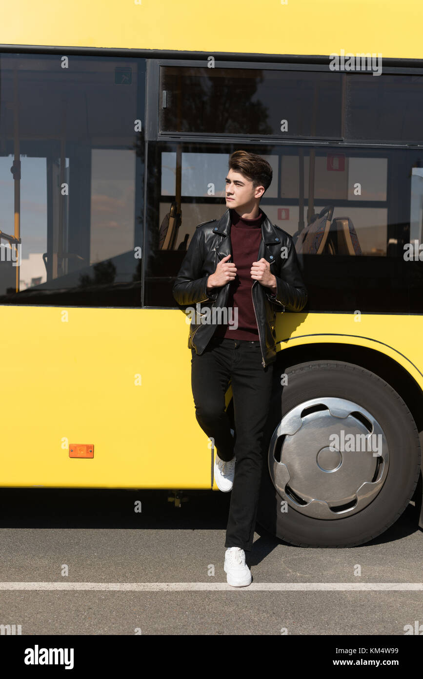 man standing near city bus Stock Photo - Alamy