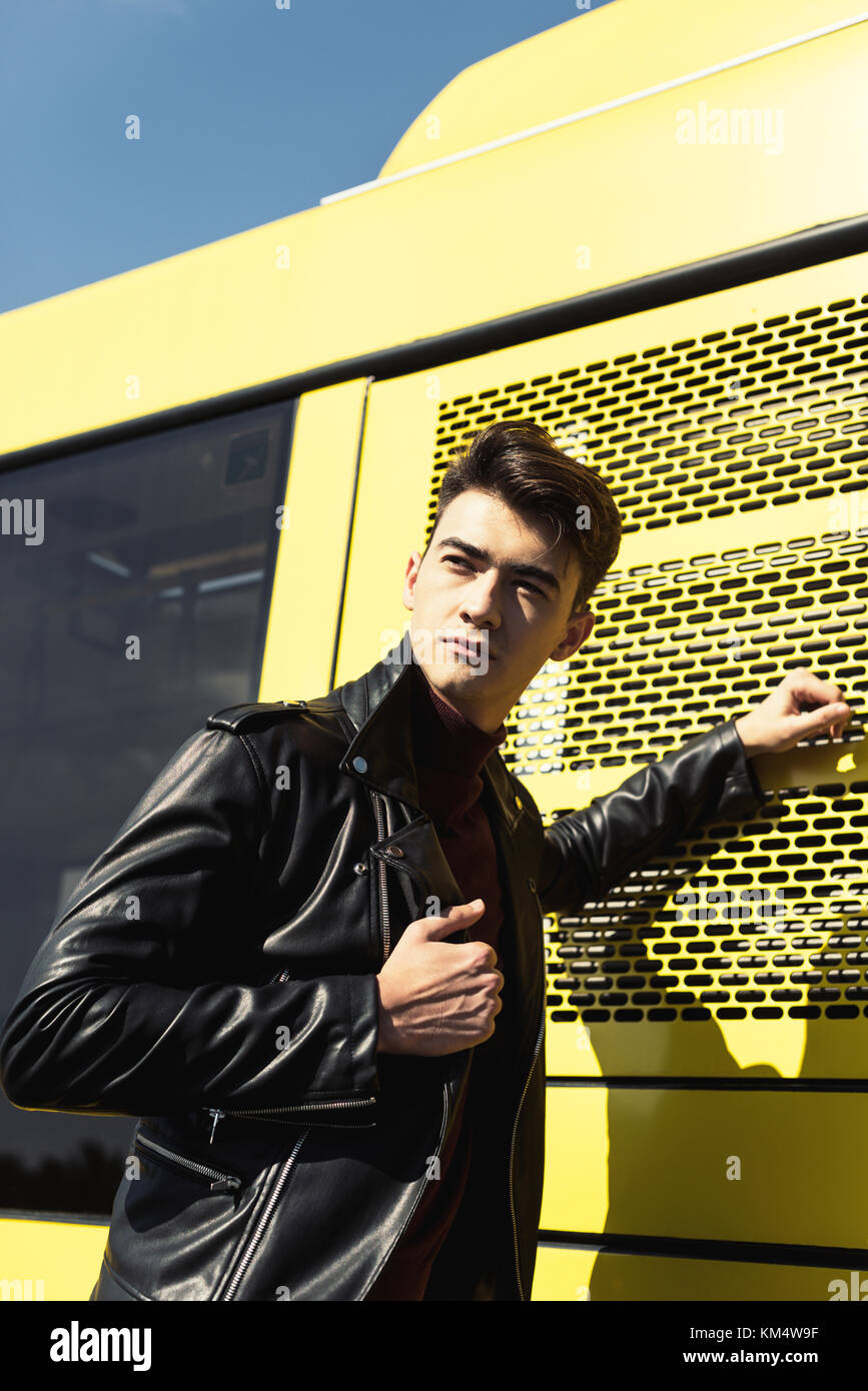 man standing near city bus Stock Photo - Alamy
