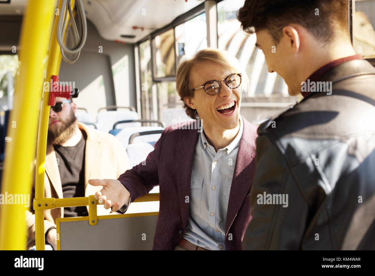 friends having conversation in public transport Stock Photo - Alamy