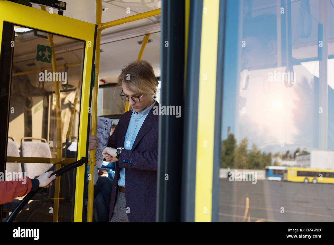 man checking time in bus Stock Photo - Alamy