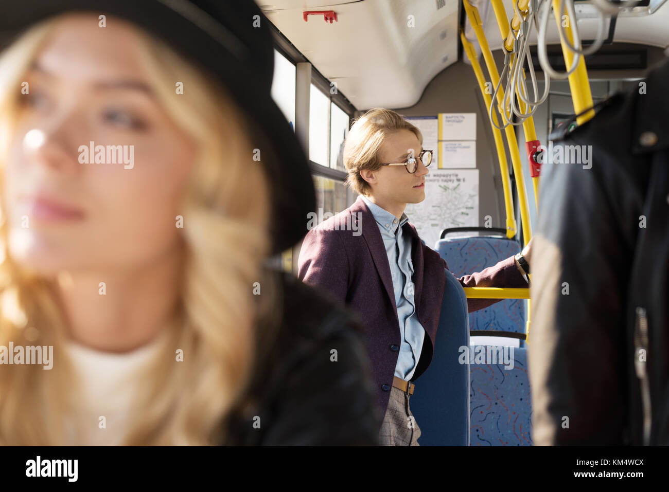 man in eyeglasses riding in city bus Stock Photo - Alamy