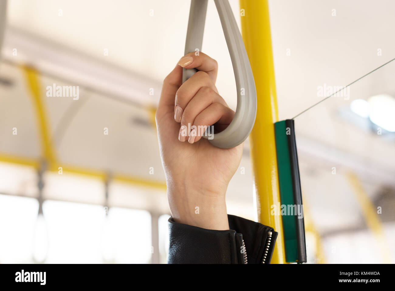 woman holding bus handle Stock Photo - Alamy