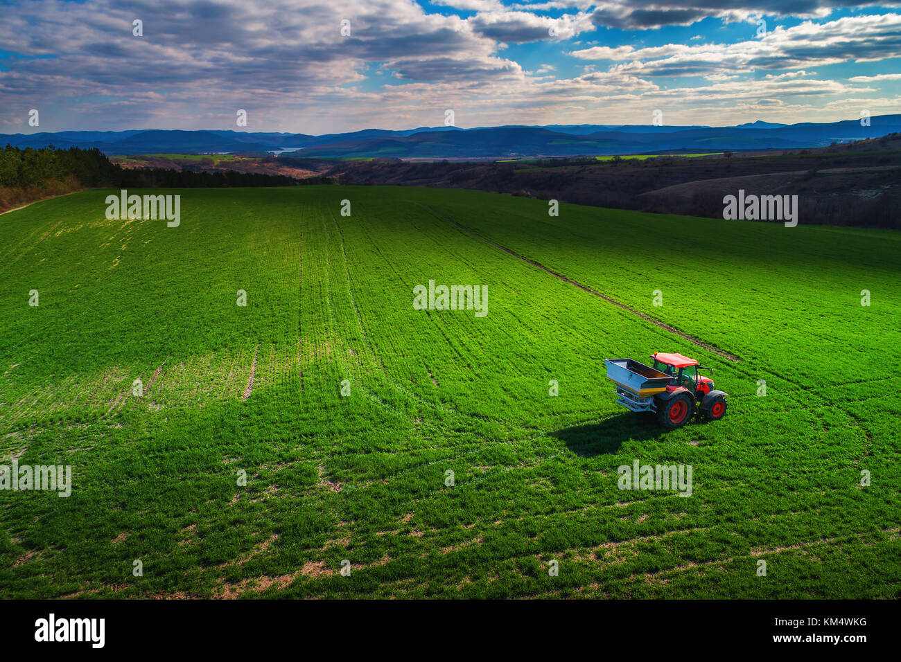 Aerial view of tractors working on the harvest field Stock Photo - Alamy