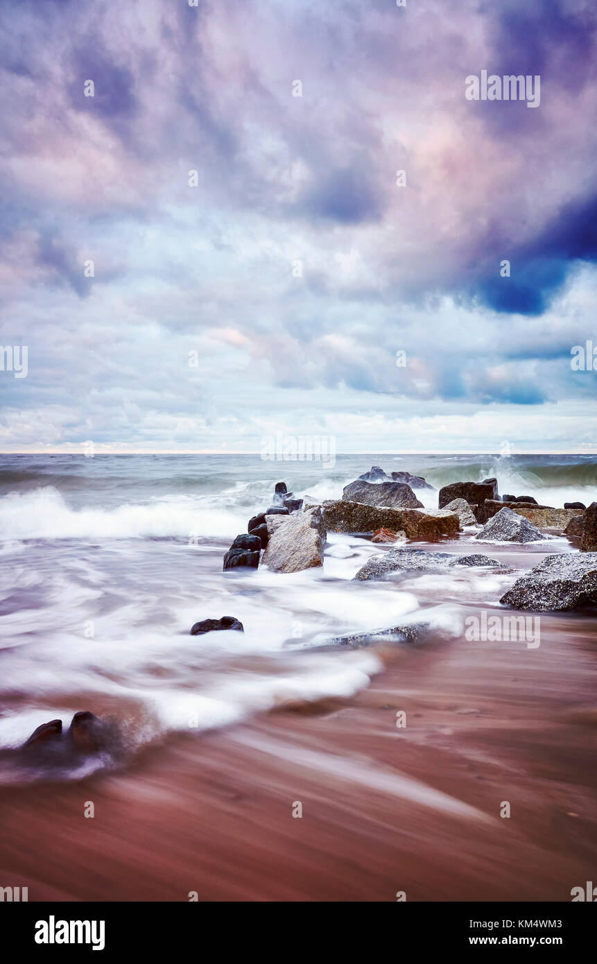 Color toned picture of an empty beach at sunset, long exposure with ...