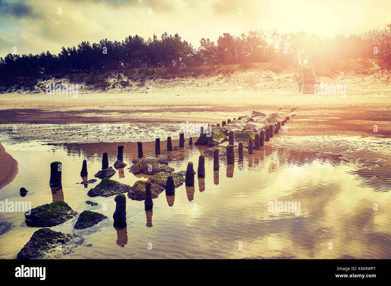 Color toned picture of an empty beach at sunset Stock Photo - Alamy