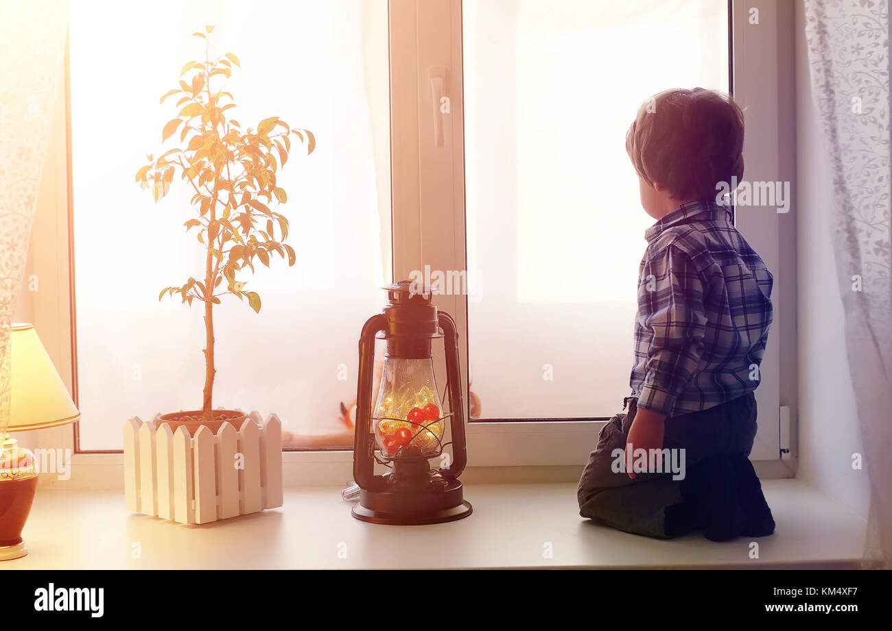 A child in the new year looks out the window. Children are waiti Stock ...