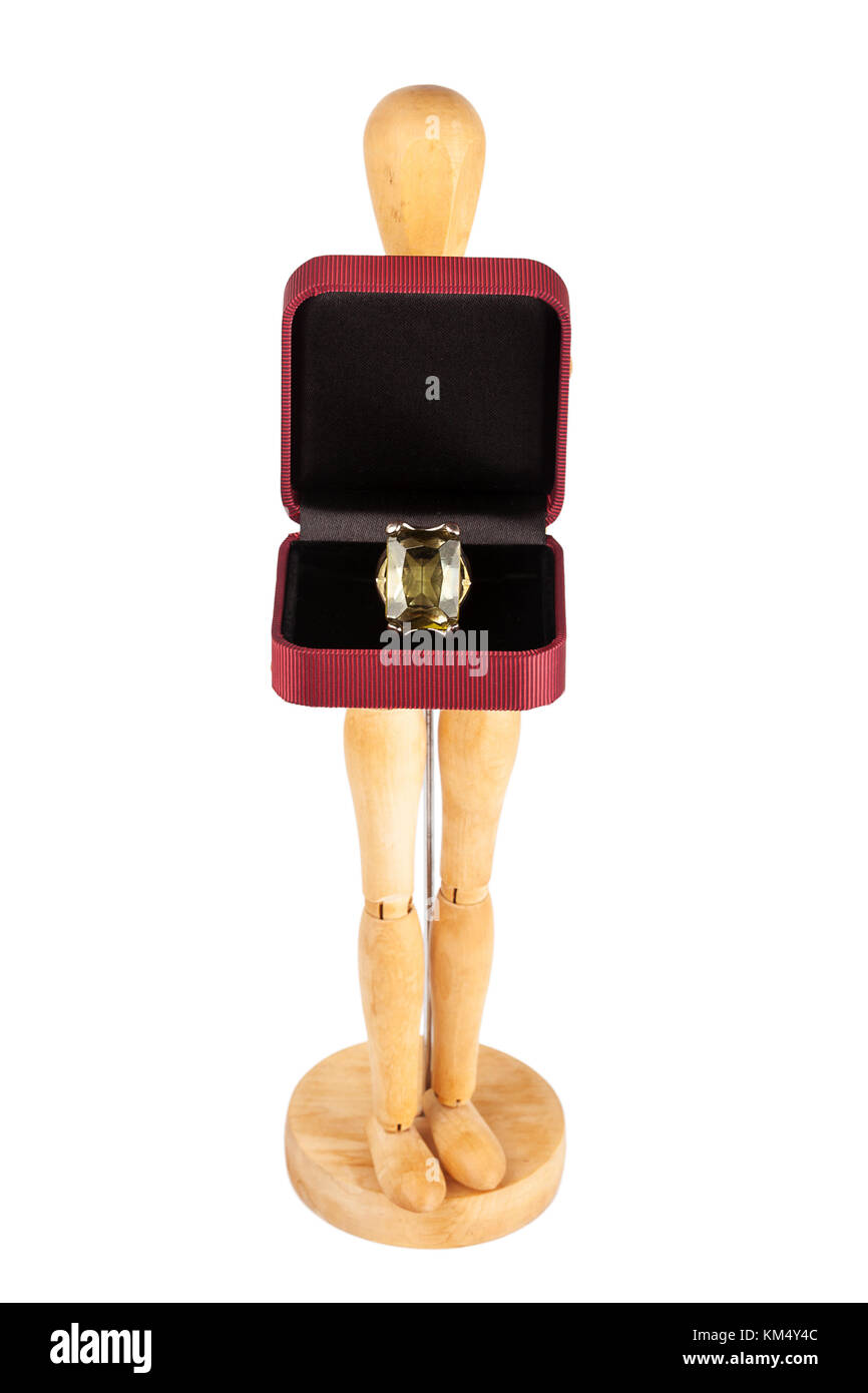 Wooden dummy carrying red gift box isolated with diamond ring on a ...