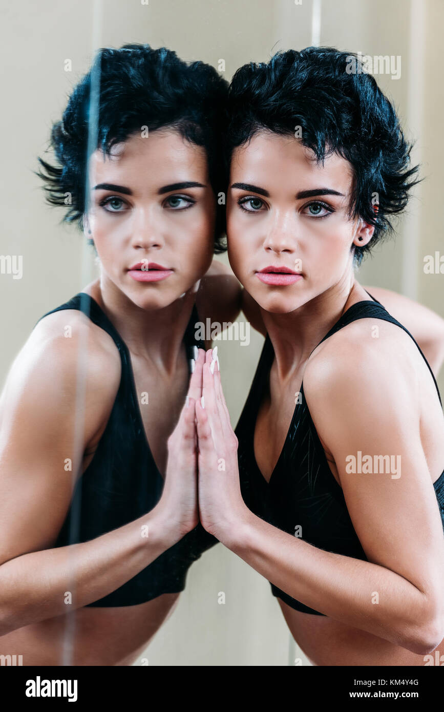 woman touching reflection in mirror Stock Photo - Alamy