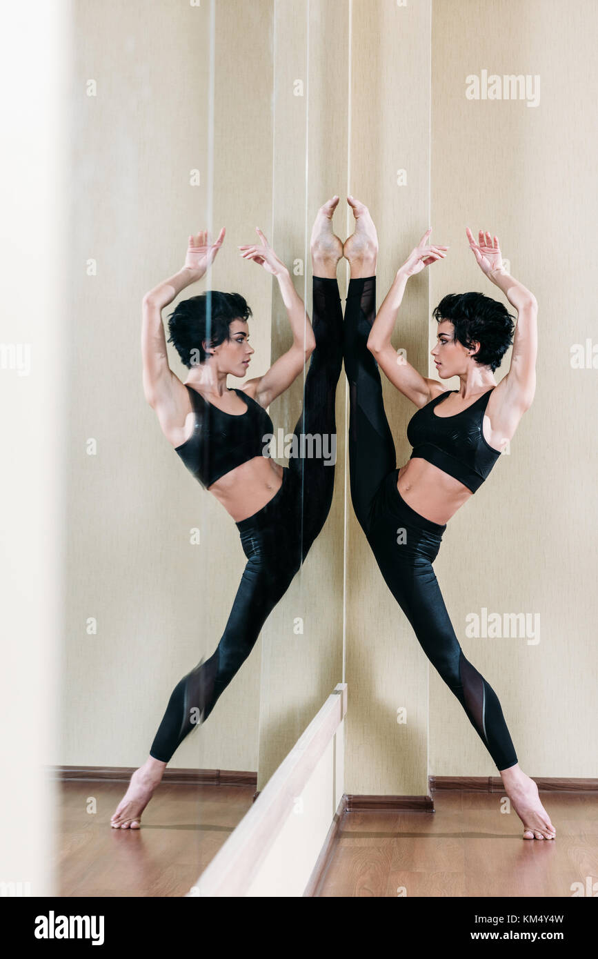 woman doing stand split at mirror Stock Photo - Alamy