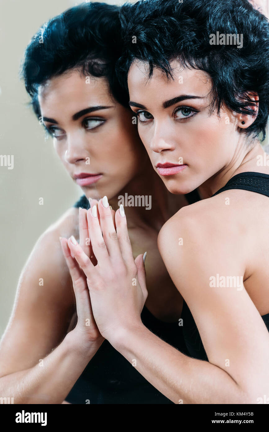 woman touching reflection in mirror Stock Photo - Alamy