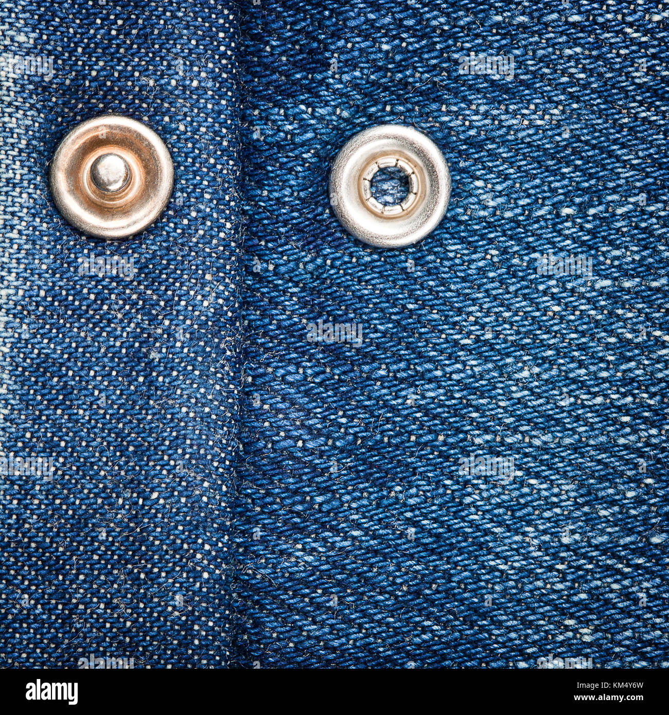 Worn blue denim jeans texture with press button Stock Photo - Alamy