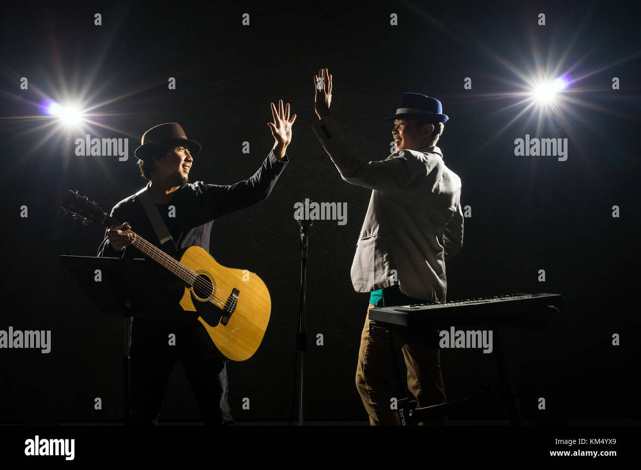 Musician Duo band playing on black background with spot light and lens ...