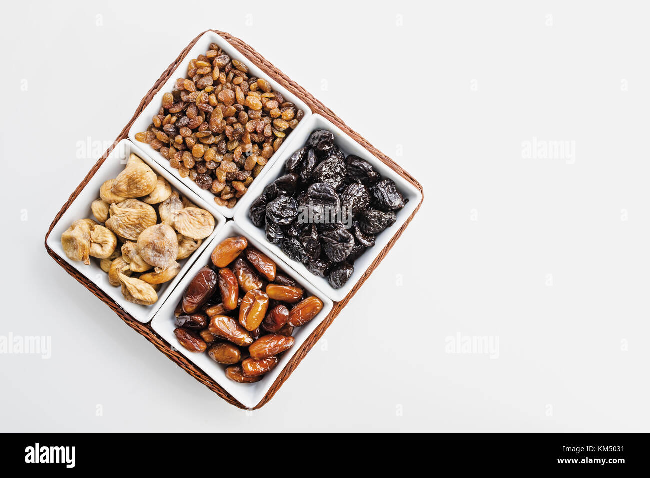 dates plums figs raisins bowls with basket 4 white background Stock ...