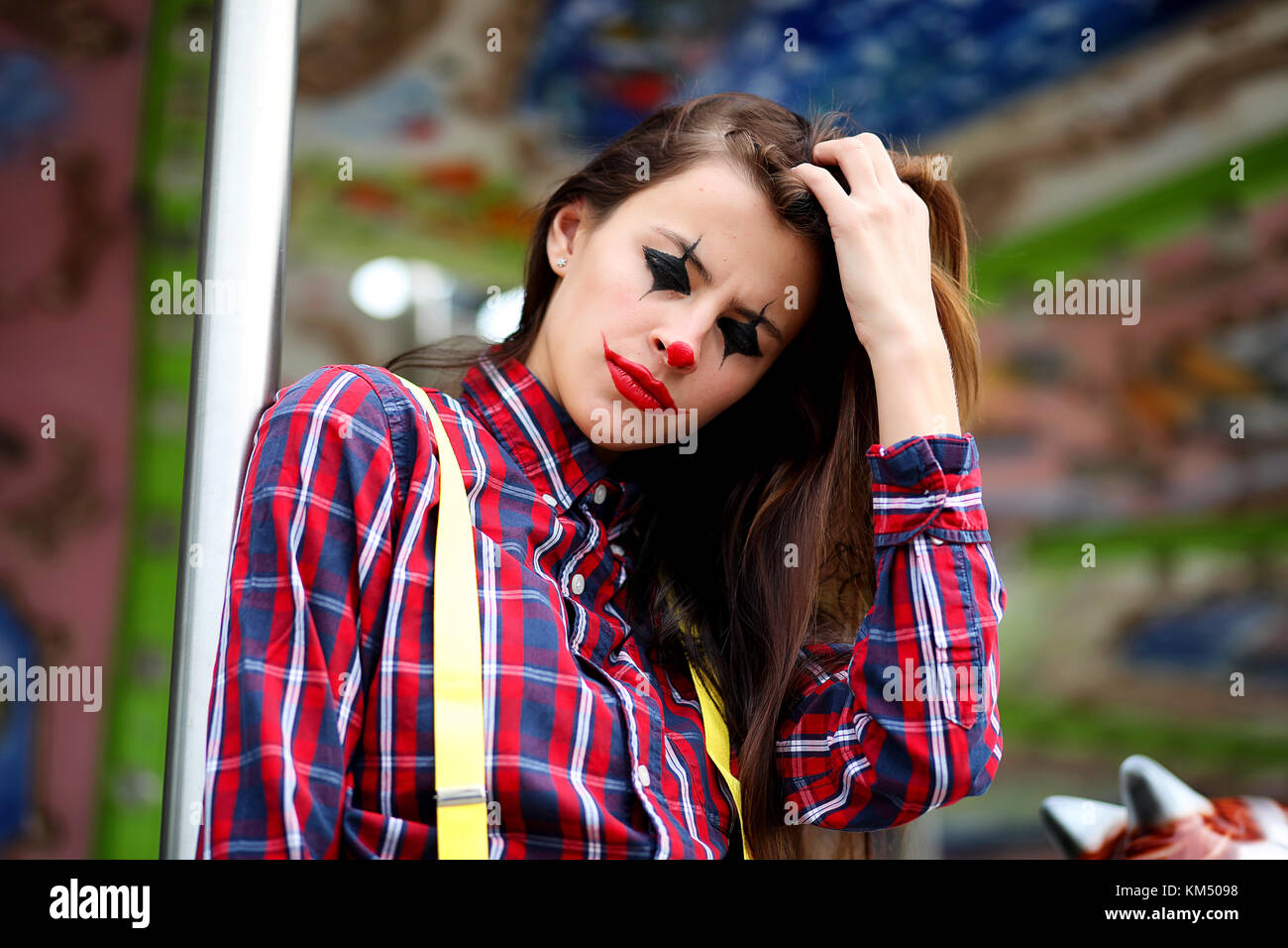 Cute girl in a clown makeup Stock Photo - Alamy