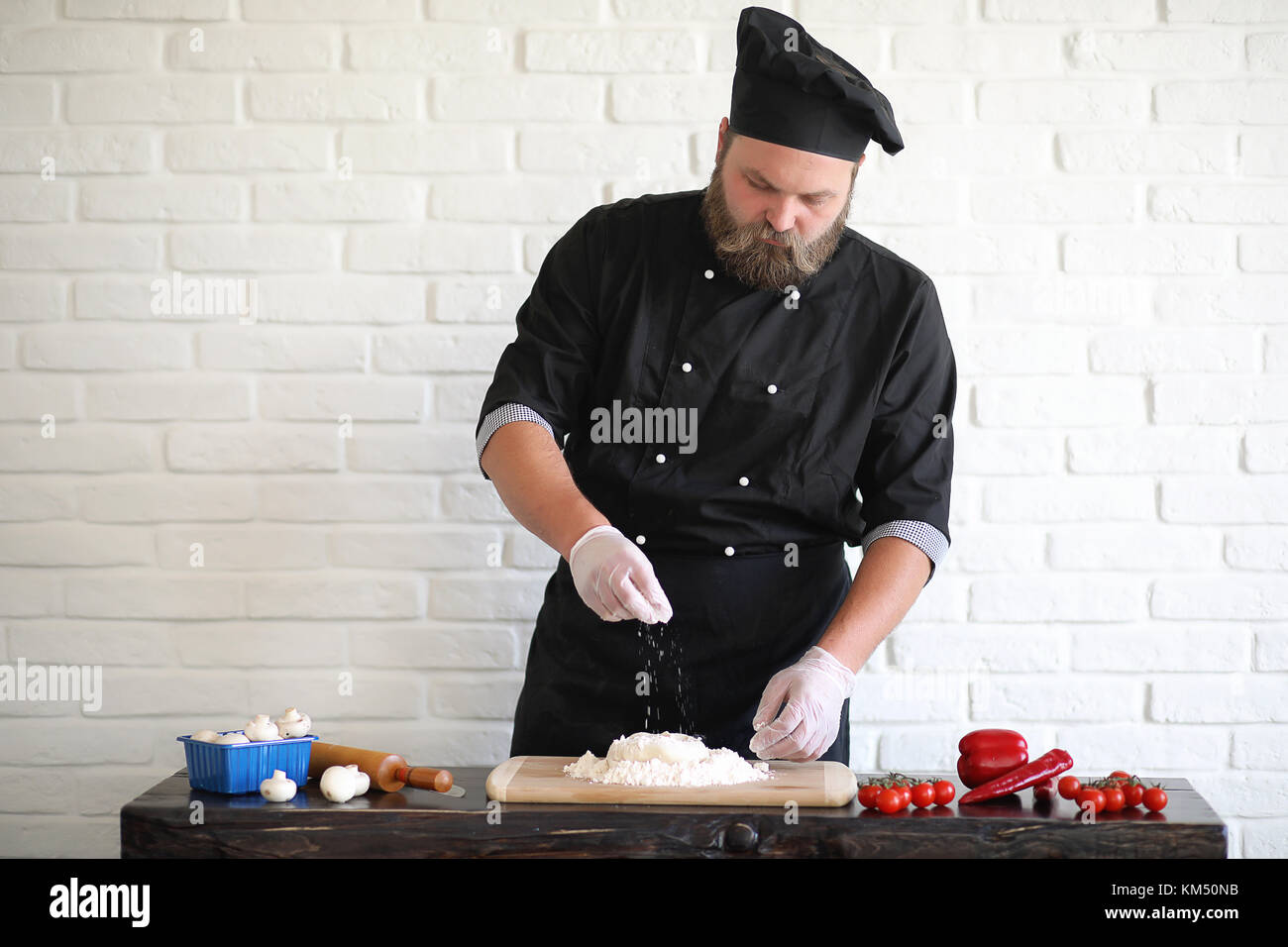 Bearded chef chef prepares meals Stock Photo - Alamy