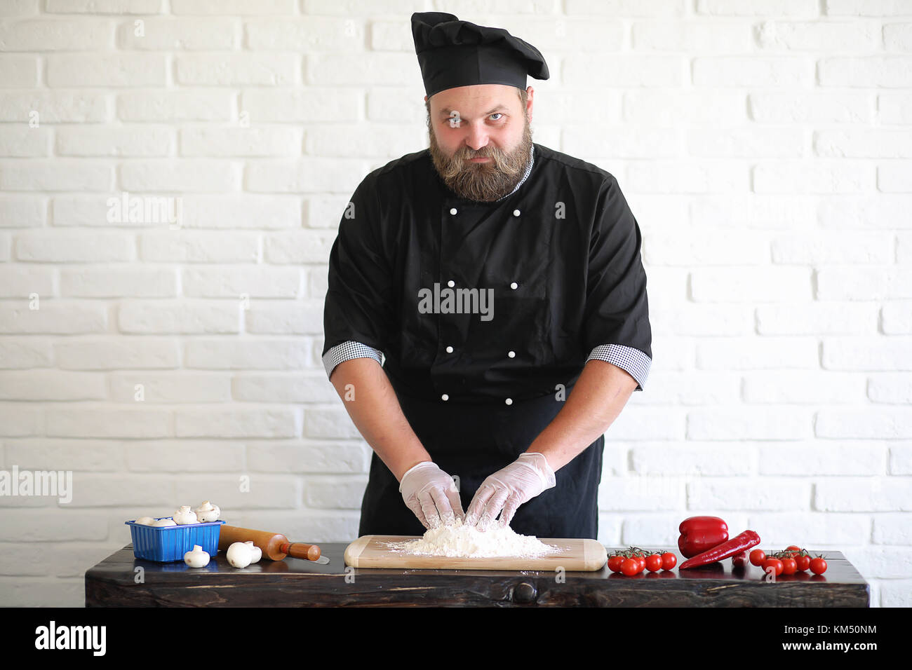 Bearded chef chef prepares meals Stock Photo - Alamy
