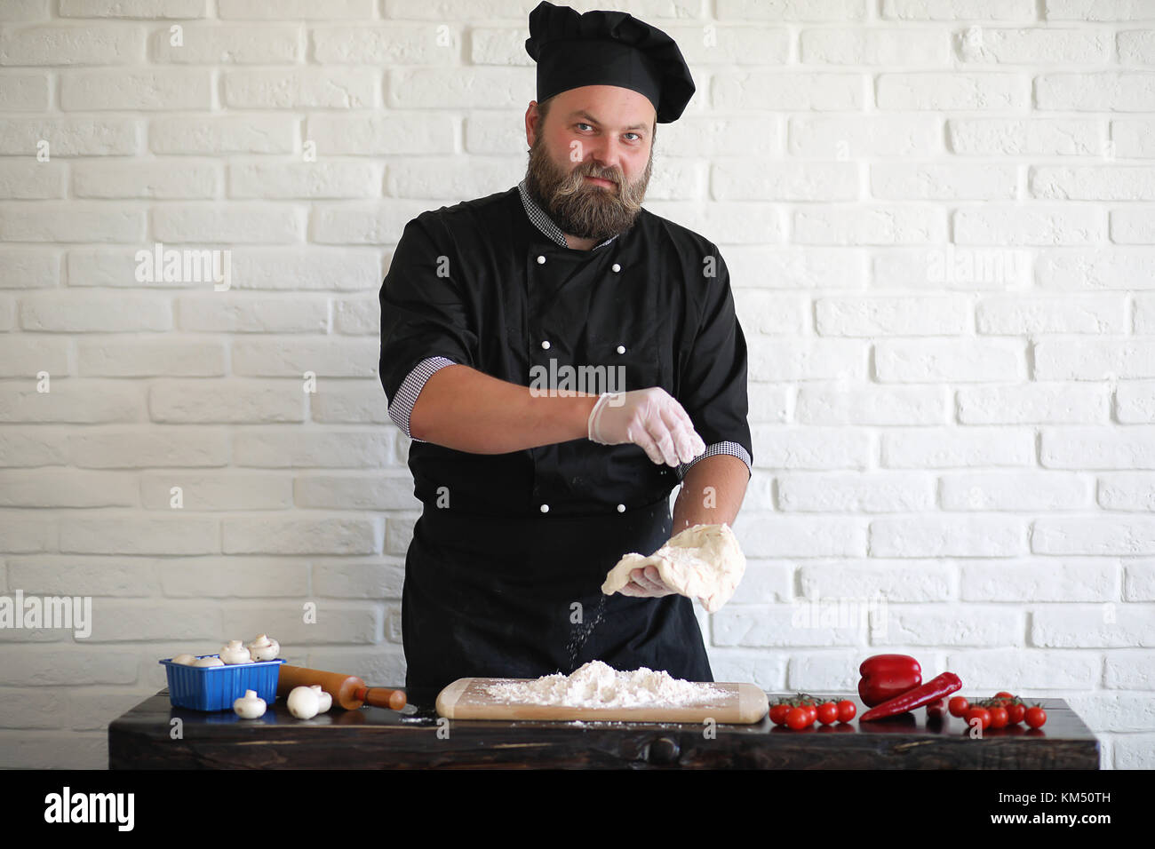 Bearded chef chef prepares meals Stock Photo - Alamy