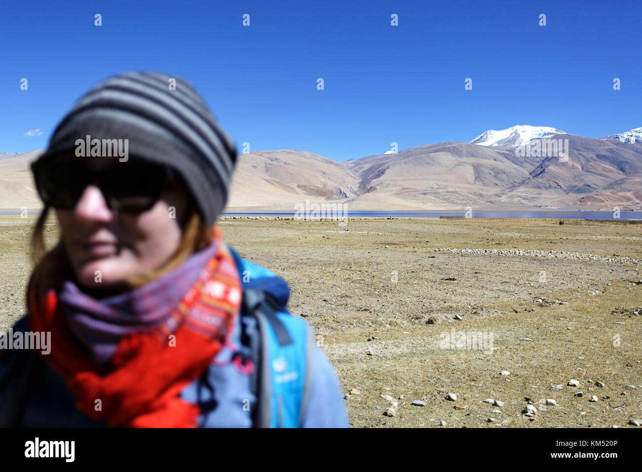 A portrait of a caucasian woman with Himalayan lake and mountains in ...