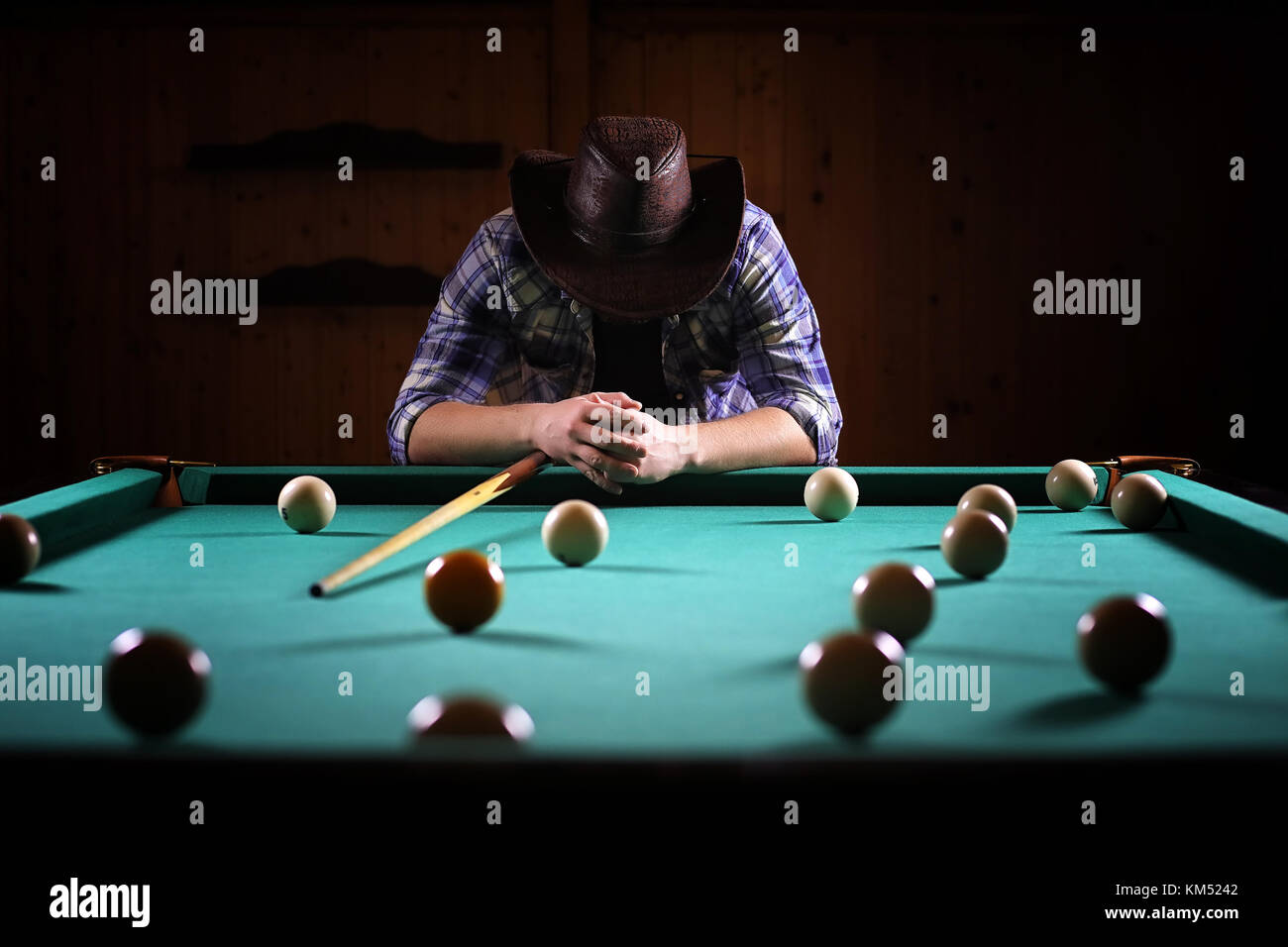 A man with a beard plays a big billiard. Party in a 12-foot pool Stock ...