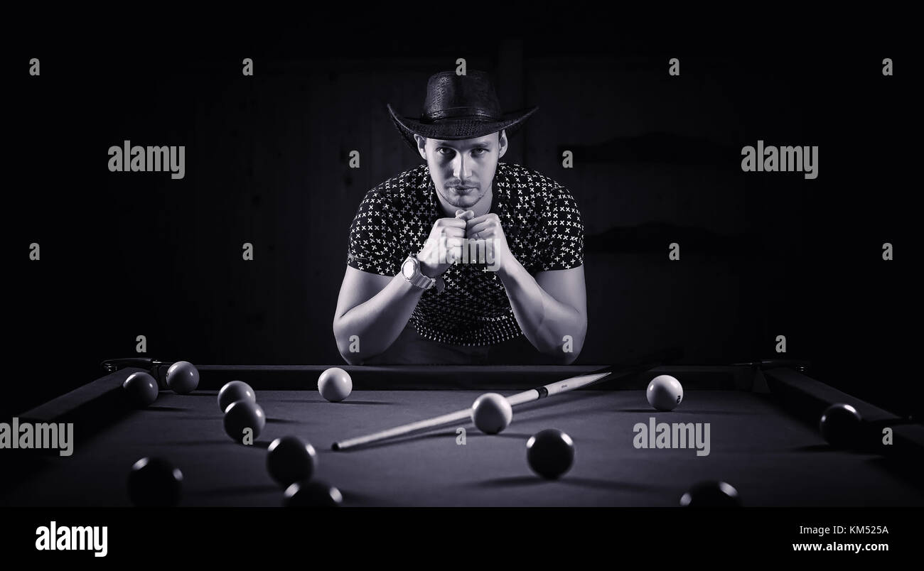 A man with a beard plays a big billiard. Party in a 12-foot pool Stock ...