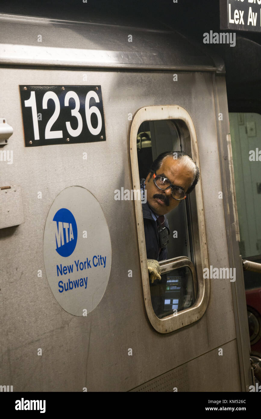 Subway train conductor in the station viewing the platform at Grand ...