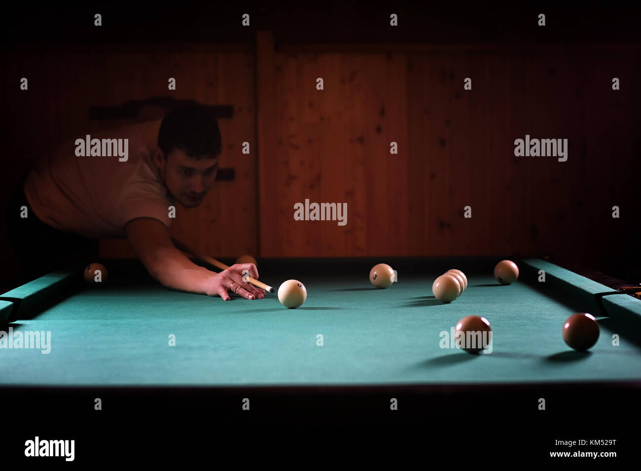 A man with a beard plays a big billiard. Party in a 12-foot pool Stock ...