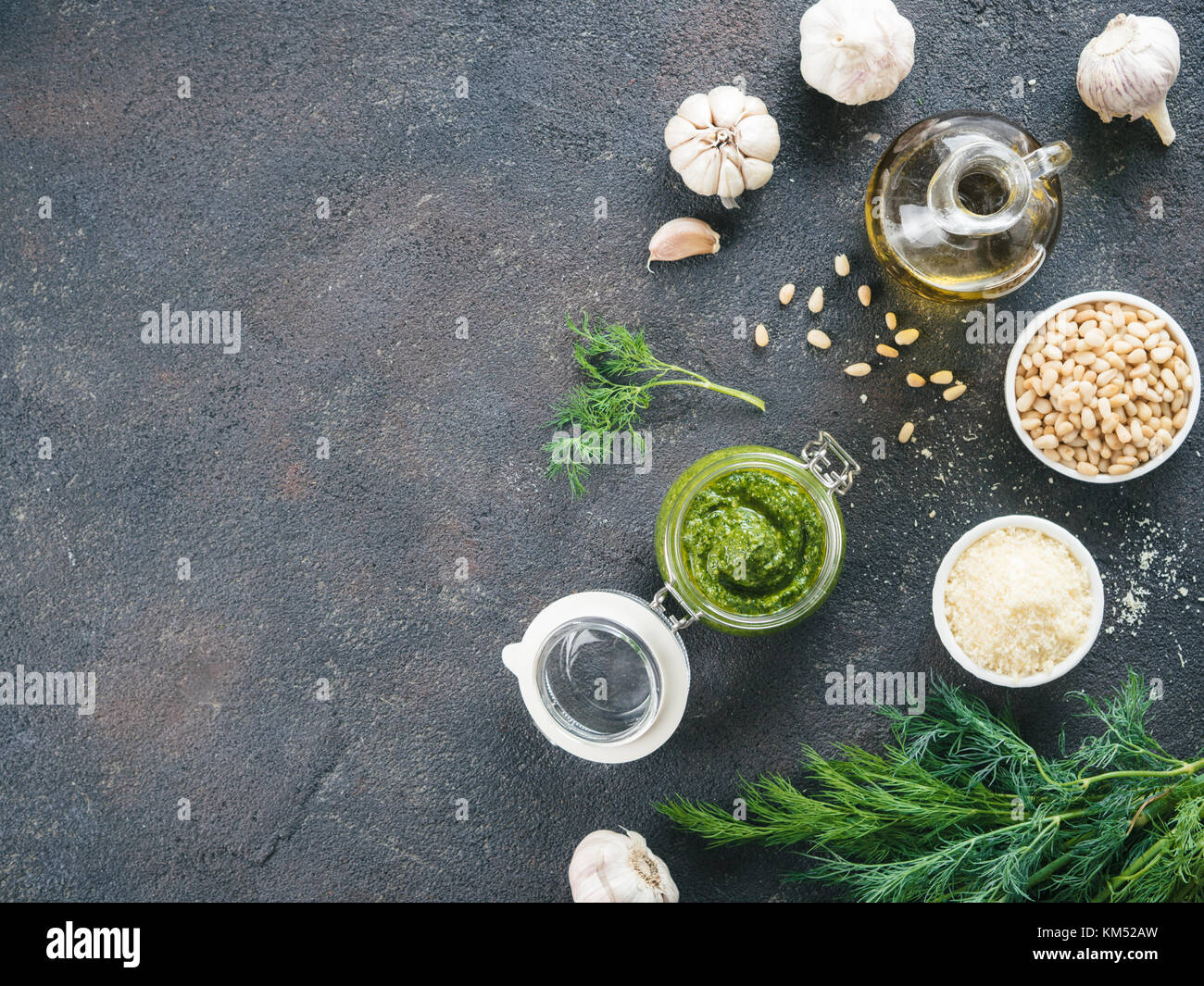 Homemade dill pesto sauce and ingredients on dark cement background ...
