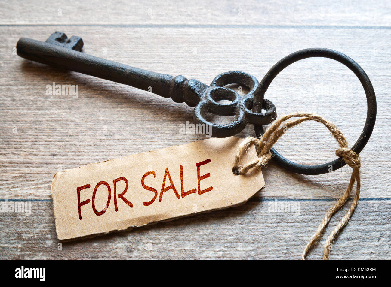 Old key with paper label - For sale text - on wooden background. Real ...