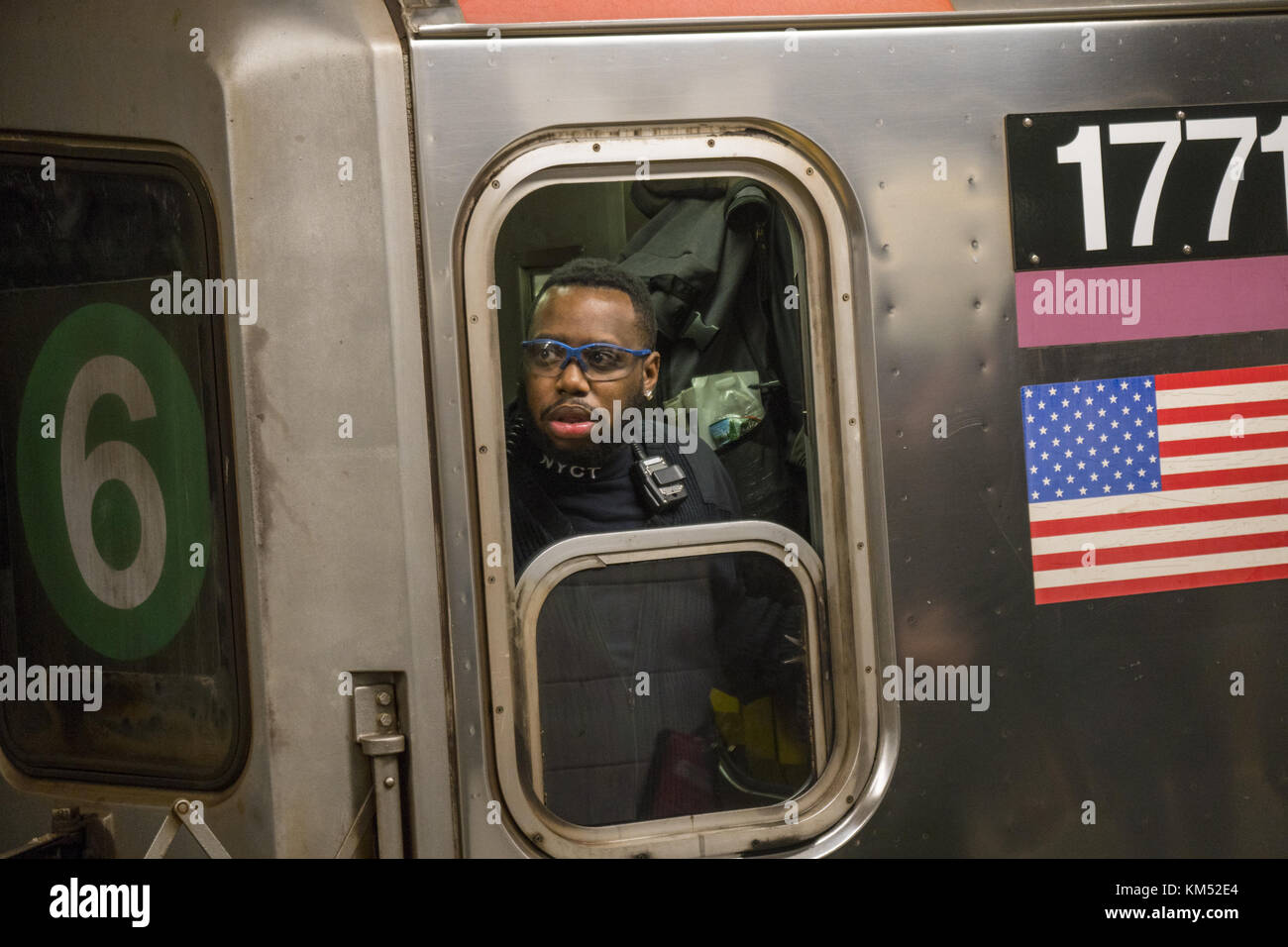 Subway train conductor in the station viewing the platform at Grand ...
