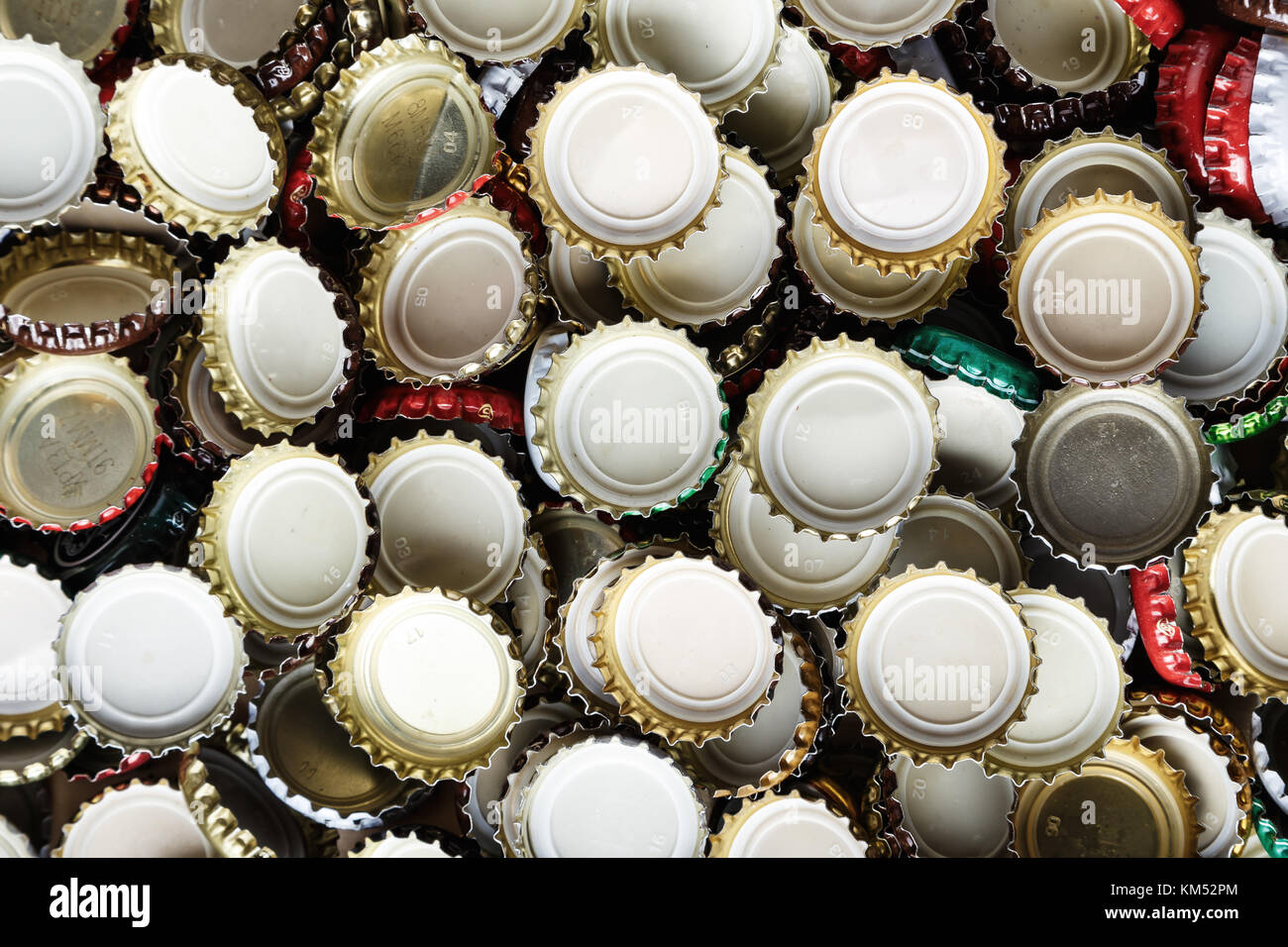many inverted covers of beer are laid out in rows, the background Stock ...