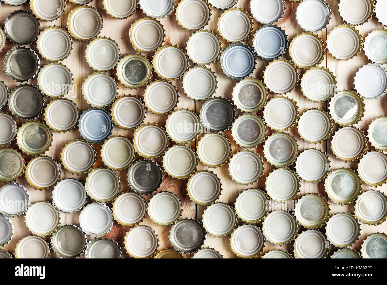 many inverted covers of beer are laid out in rows, the background. top ...