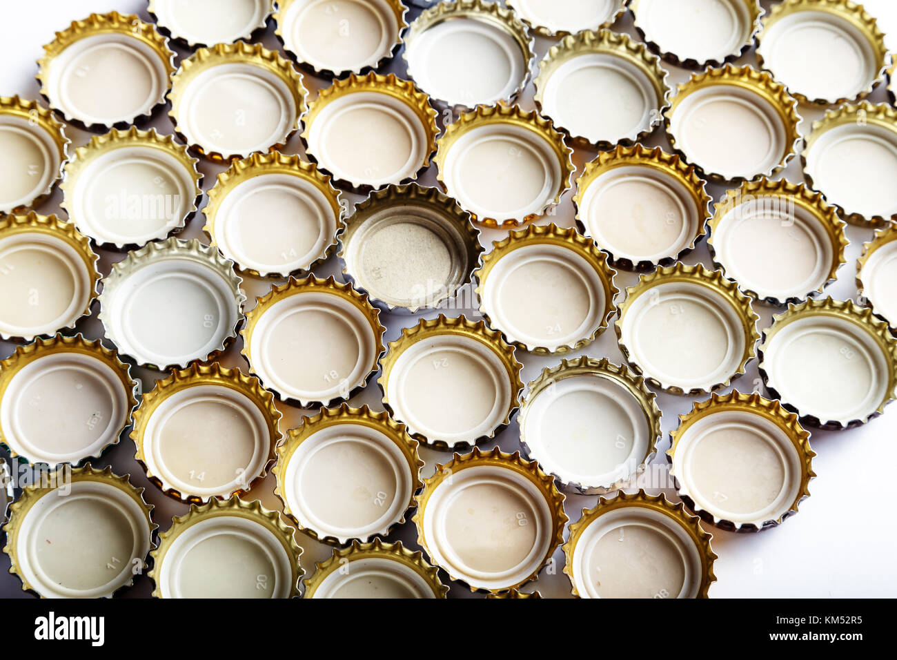 many inverted covers of beer are laid out in rows, the background. top ...