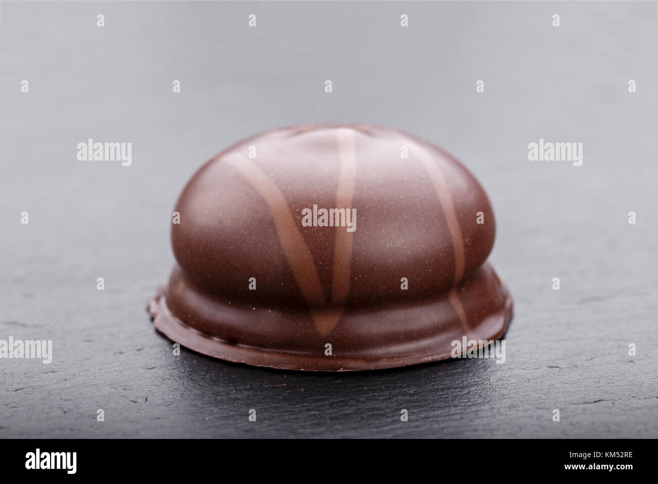 round chocolate candy on a black slate board Stock Photo - Alamy