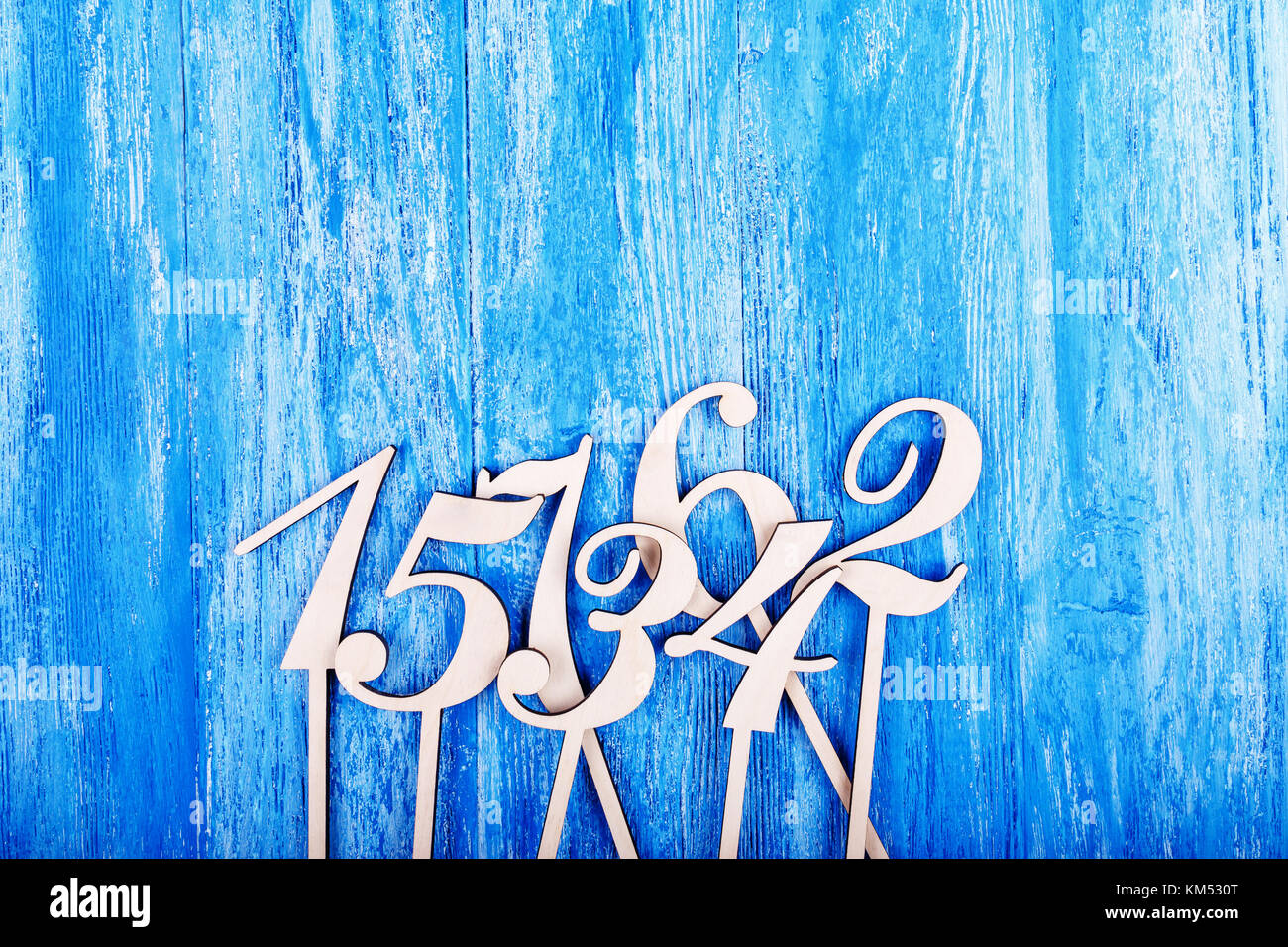 wooden numbers one, two, three, four, five, six, seven, scattered on a ...