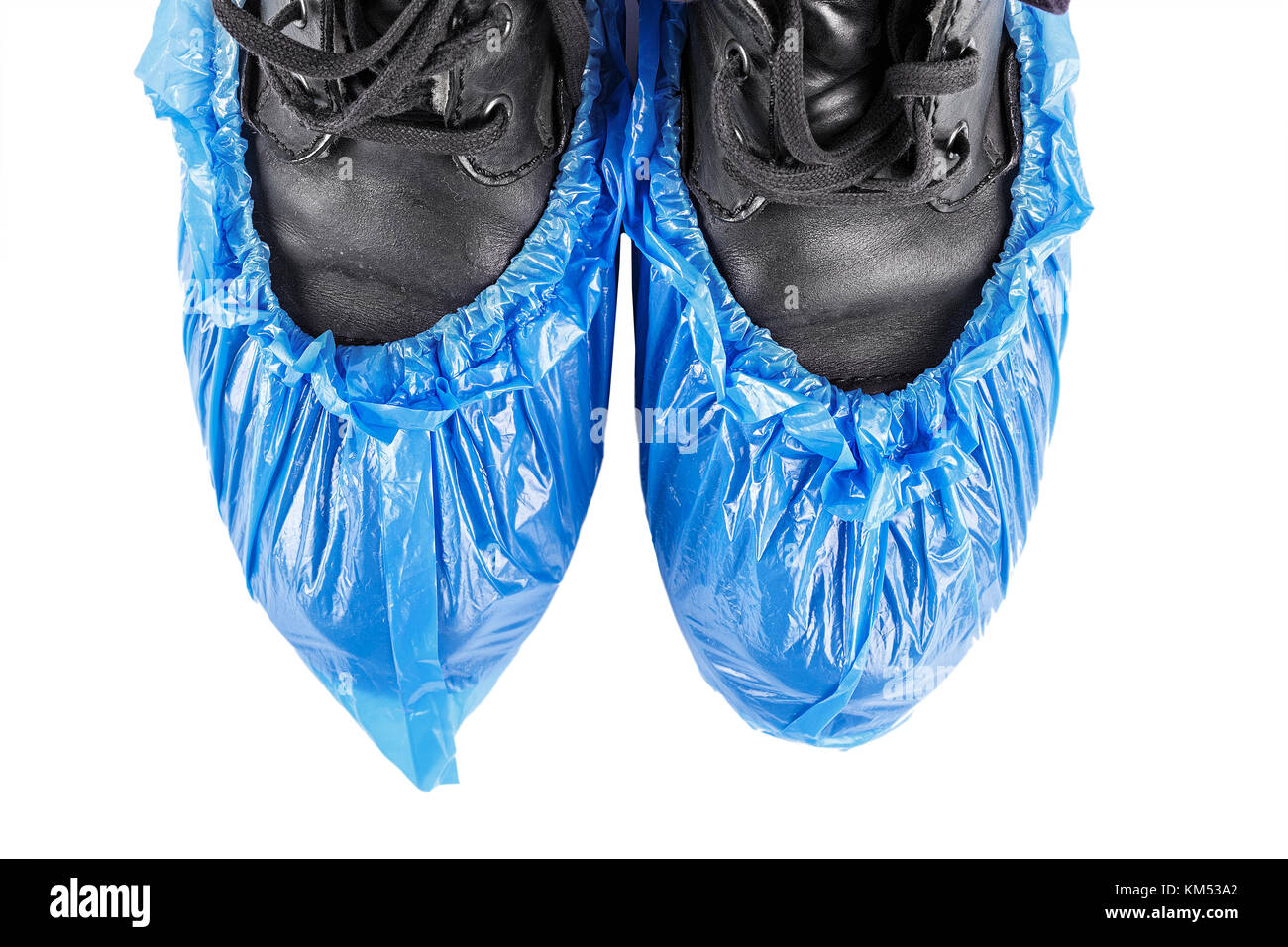 blue protective shoe covers on men's shoes isolated on white background ...