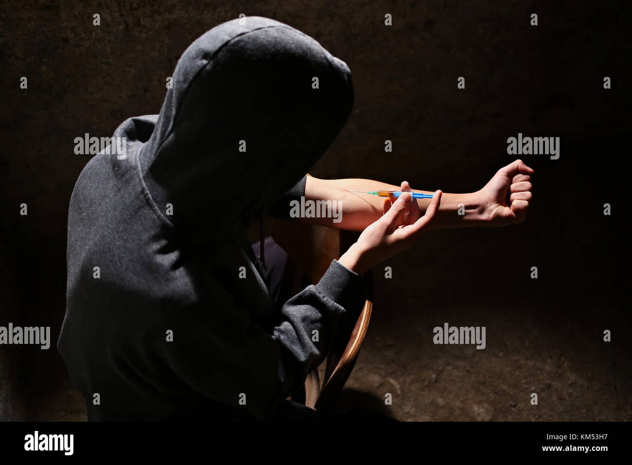 Drugs concept. Disease concept. Drug addict man with syringe using ...