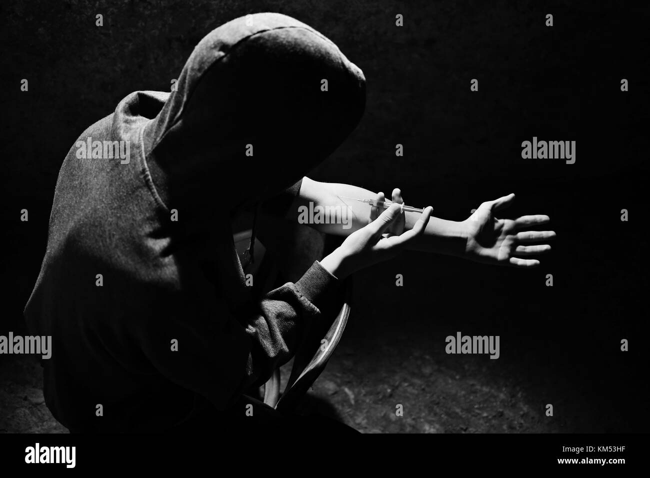 Drugs concept. Disease concept. Drug addict man with syringe using ...