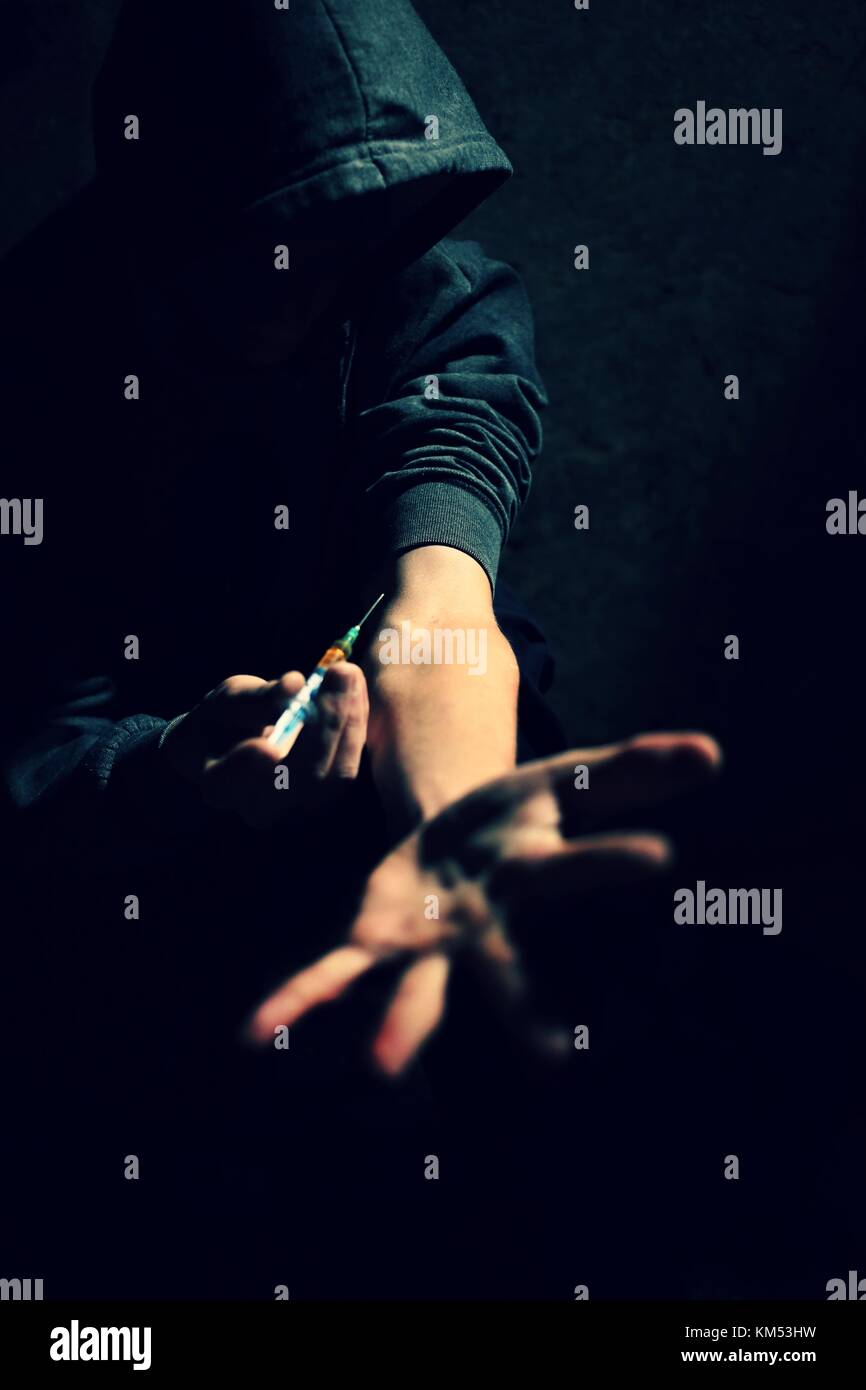 Drugs concept. Disease concept. Drug addict man with syringe using ...