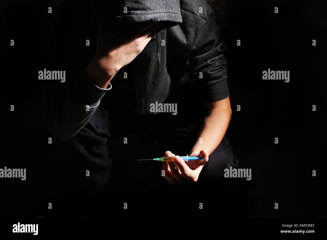 Drugs concept. Disease concept. Drug addict man with syringe using ...