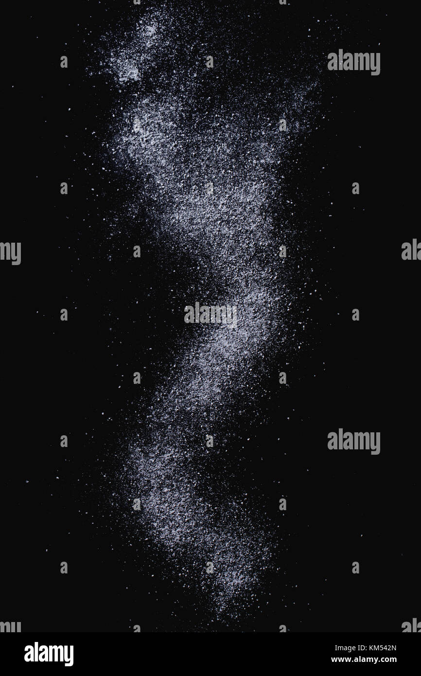 Sifting sugar powder over black background Stock Photo - Alamy