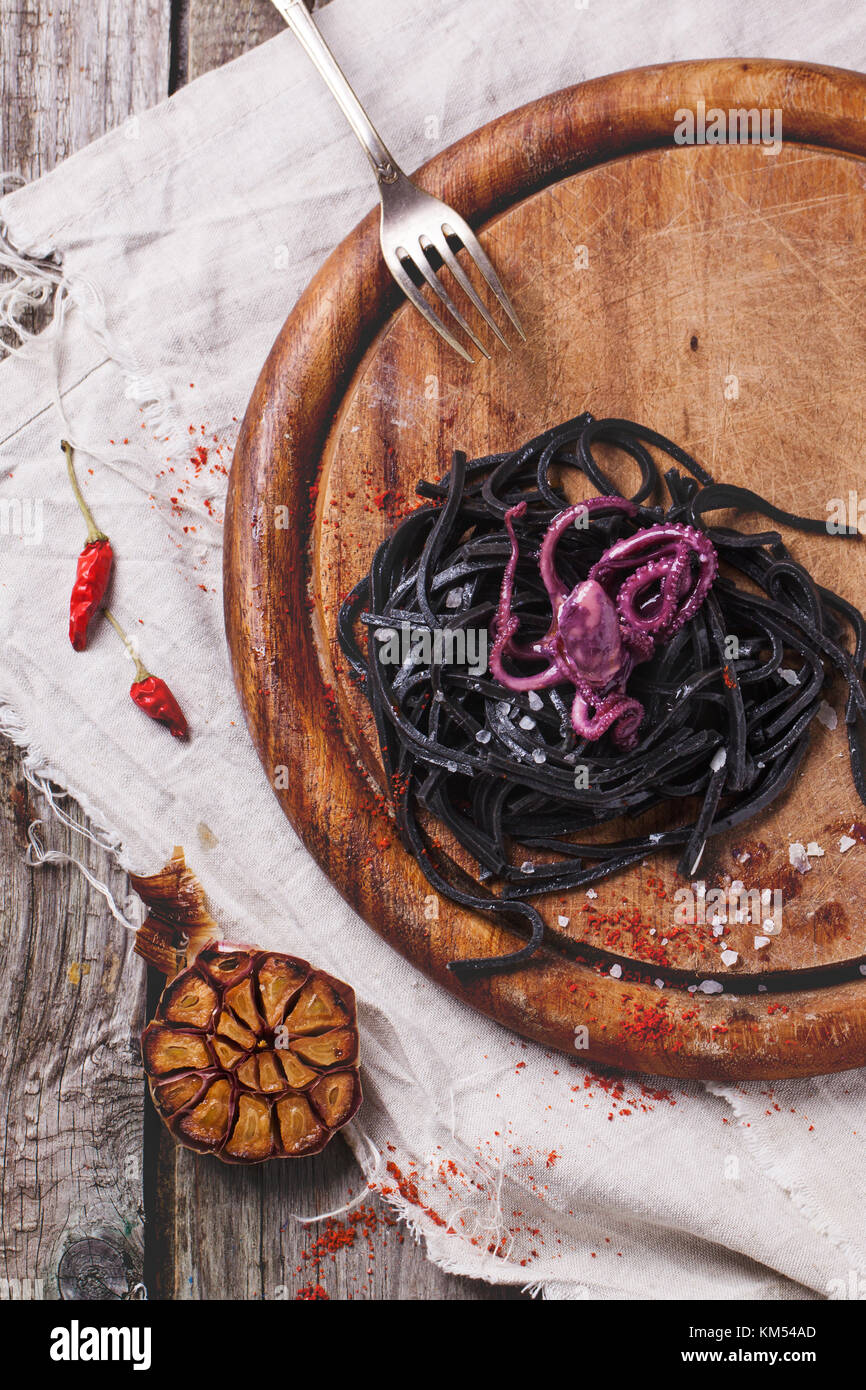 Top view on black spaghetti (pasta with cuttlefish ink) with marinated ...
