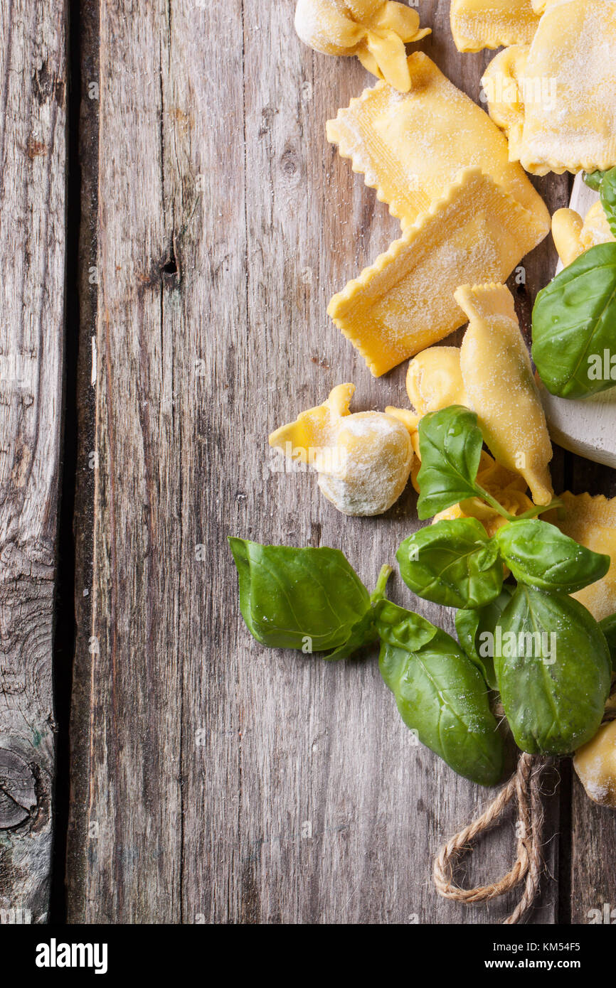 Top view on homemade pasta ravioli and perle on old wooden table with ...