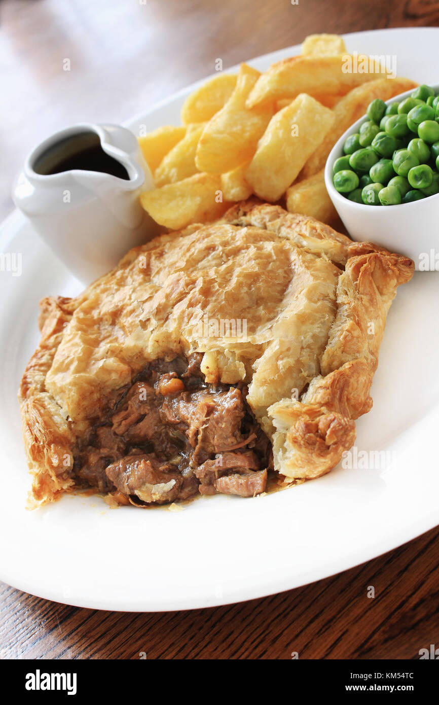 traditional beef steak pie with chips and peas Stock Photo - Alamy