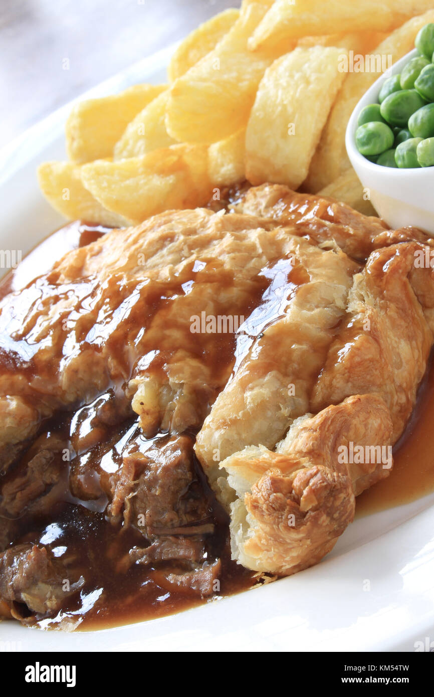 traditional beef steak pie with chips and peas Stock Photo - Alamy
