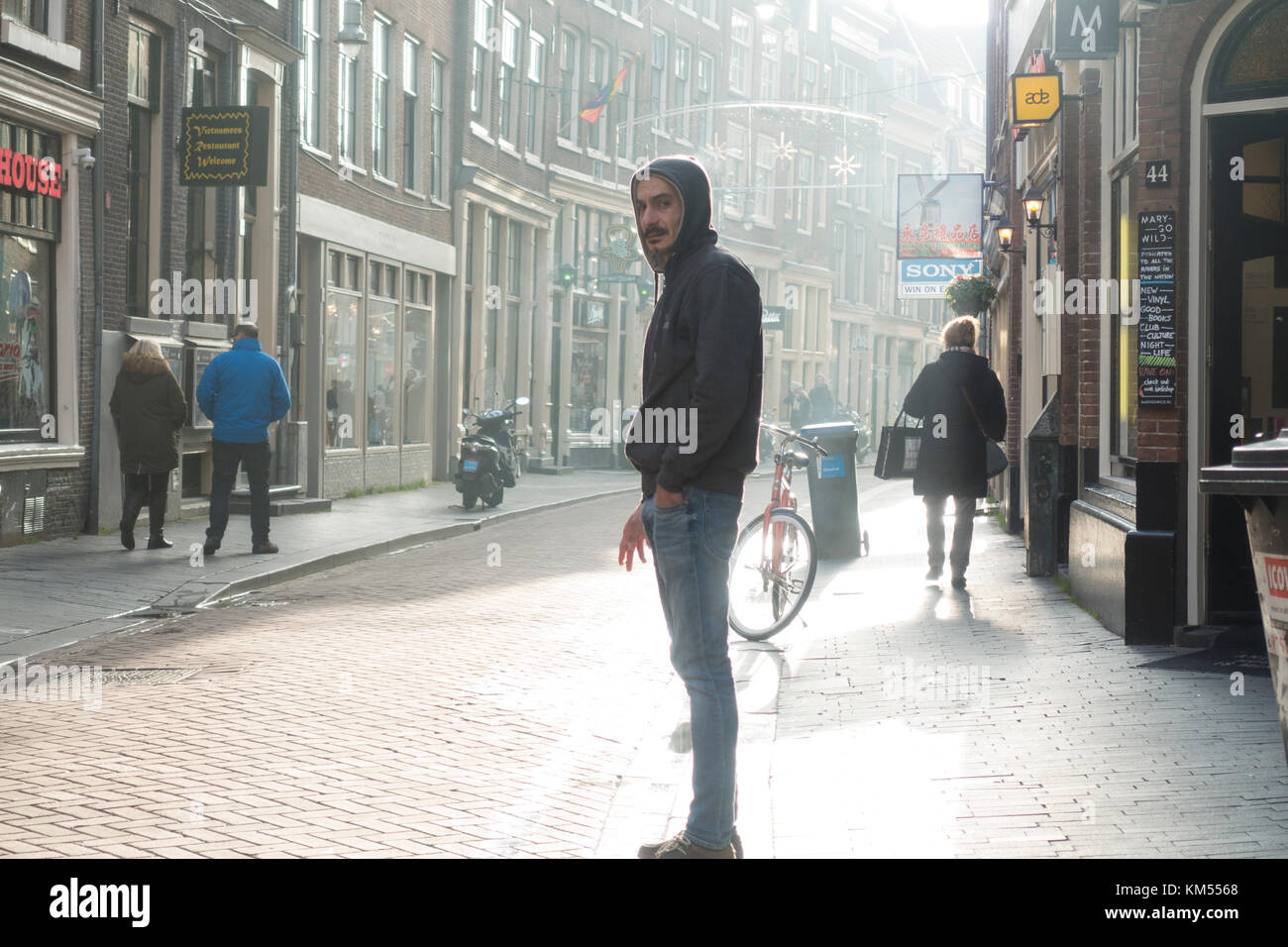 Man standing alone on Amsterdam street Stock Photo - Alamy