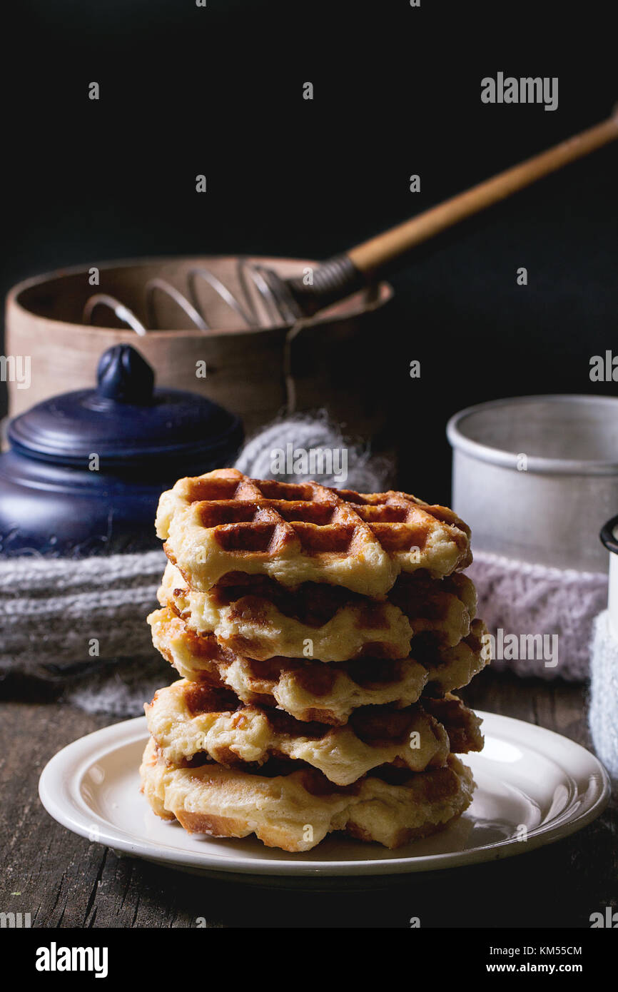 White plate with homemade belgian waffles with two vintage cup of tea ...