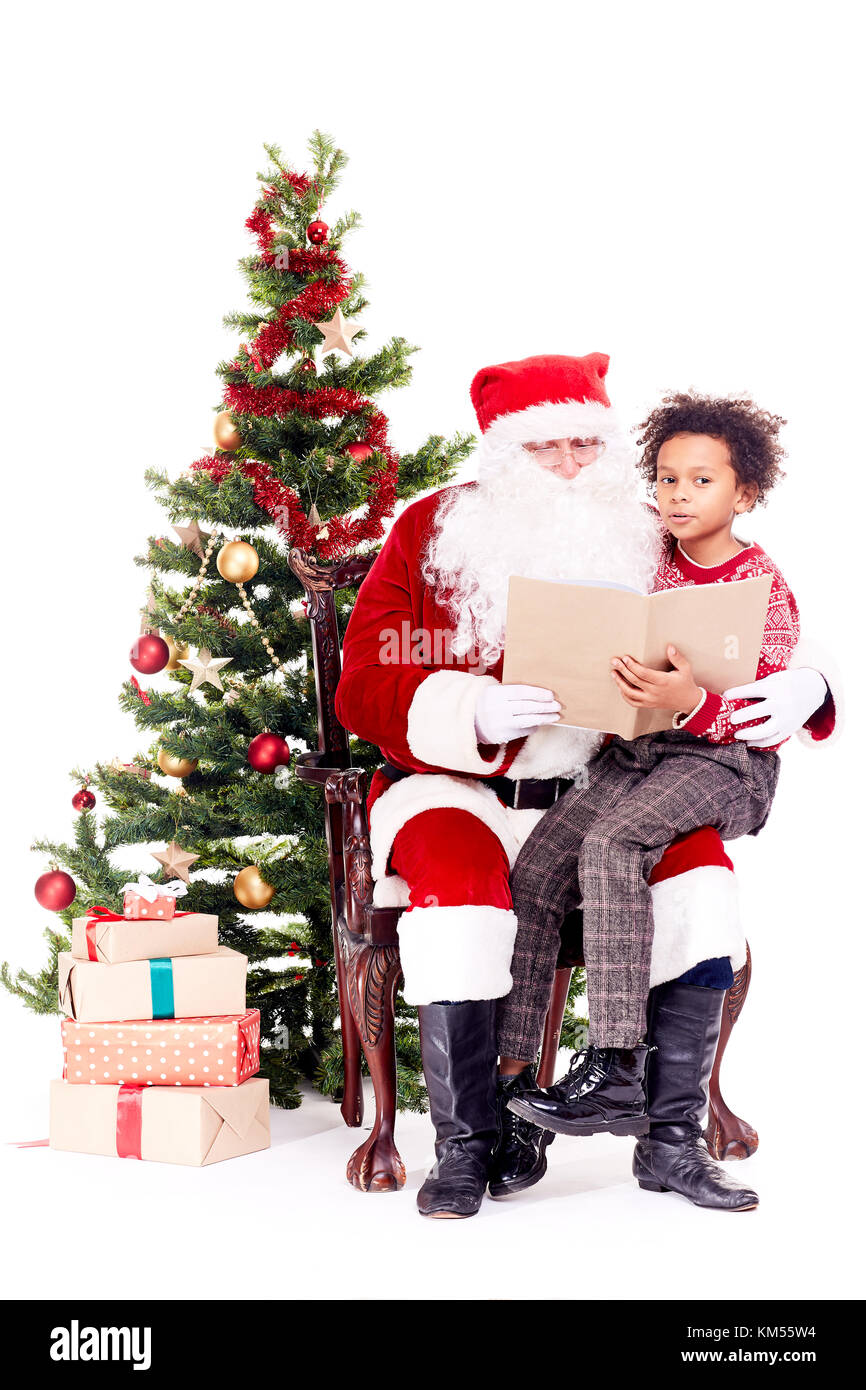 Santa reading Christmas story for kid Stock Photo - Alamy